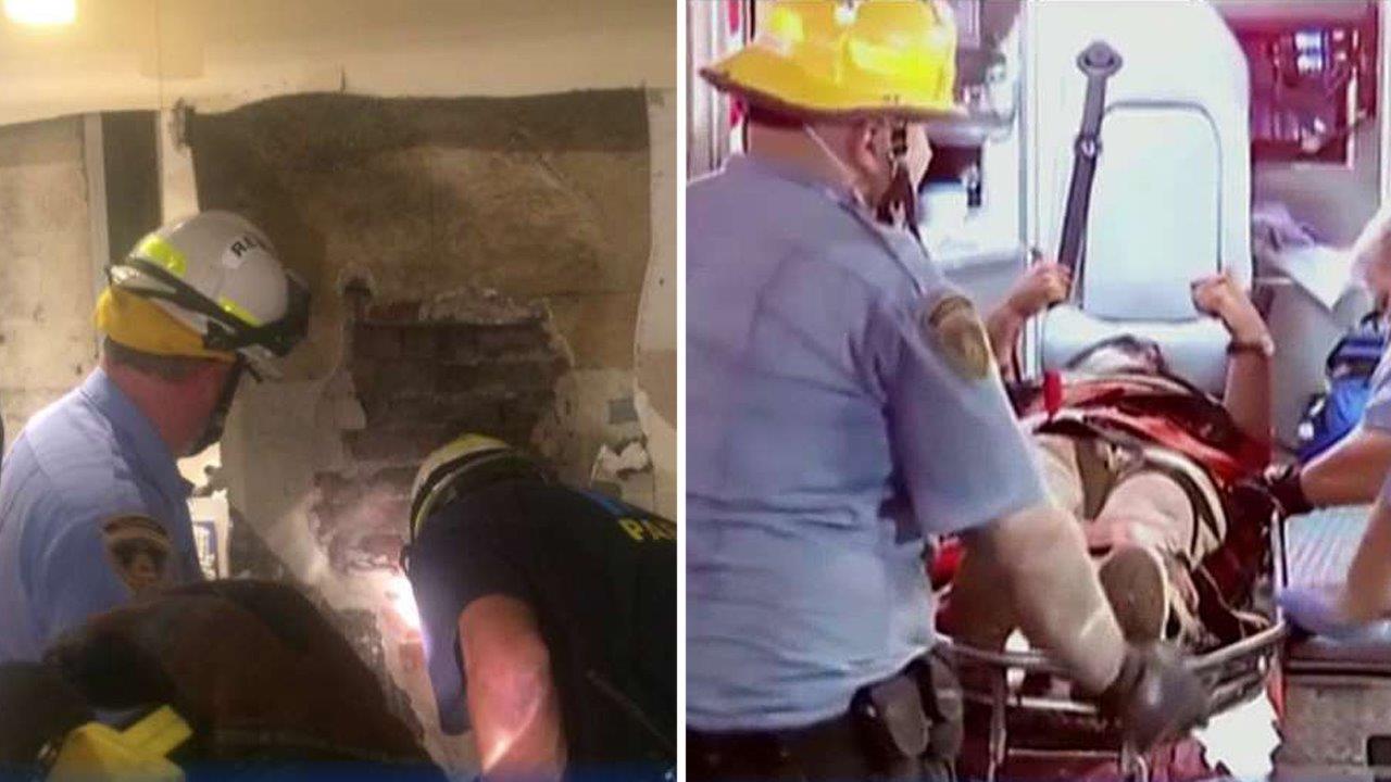 Crews free man stuck between buildings after bid to impress | Fox News